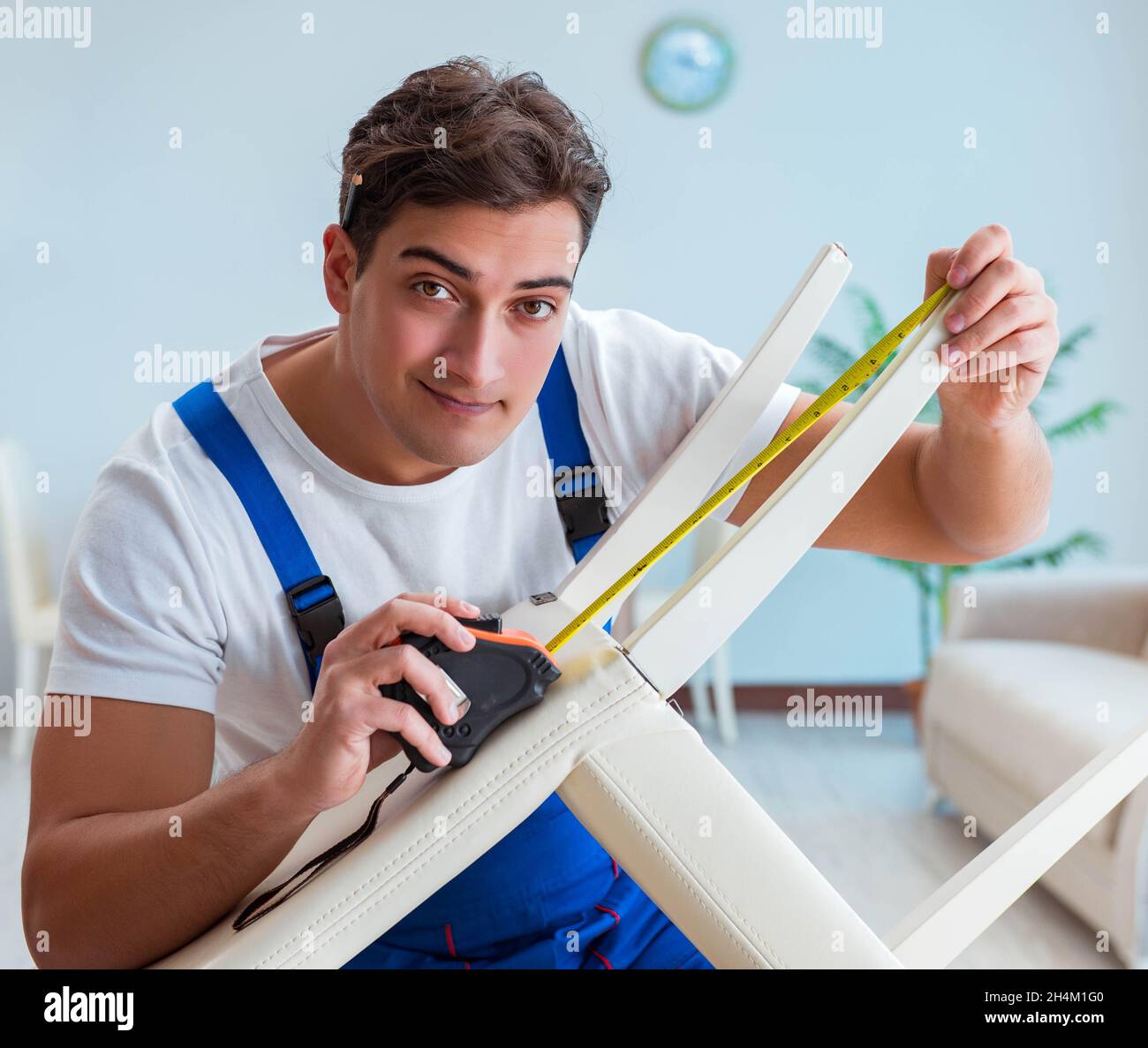 The repairman repairing broken chair at home Stock Photo - Alamy