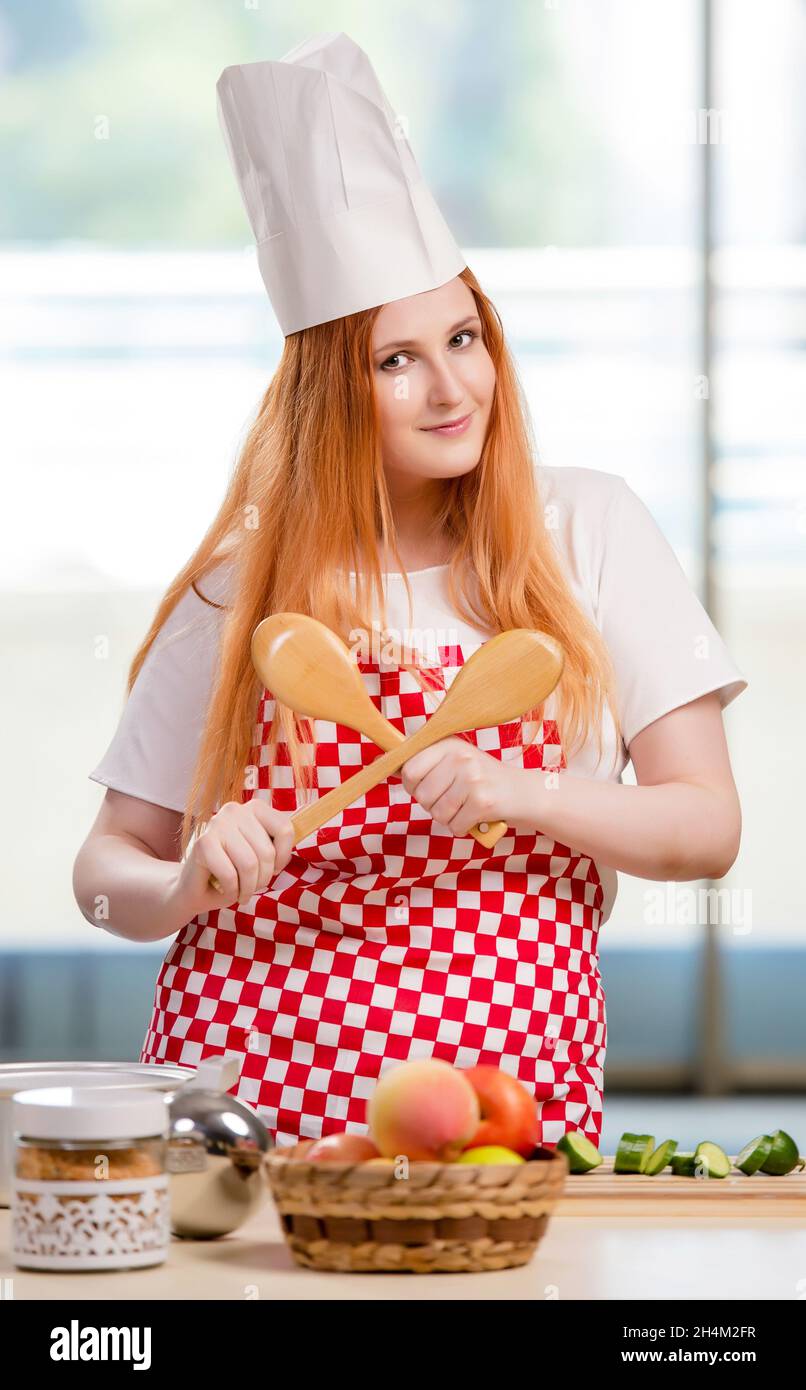 The redhead cook working in the kitchen Stock Photo - Alamy