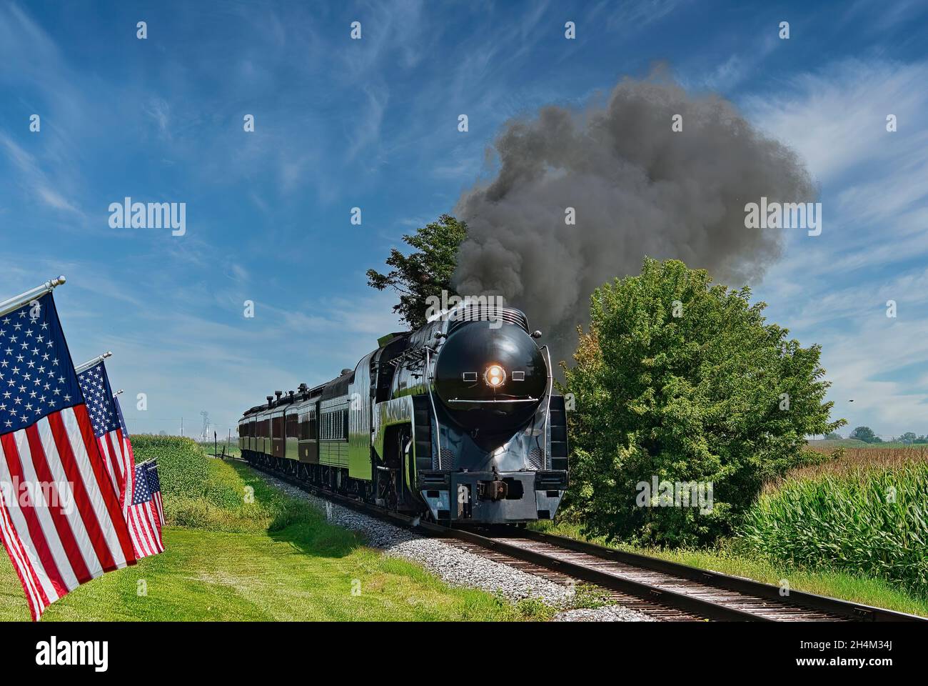 A Antique Restored Steam Engine Approaching Head on Passing a Row of ...