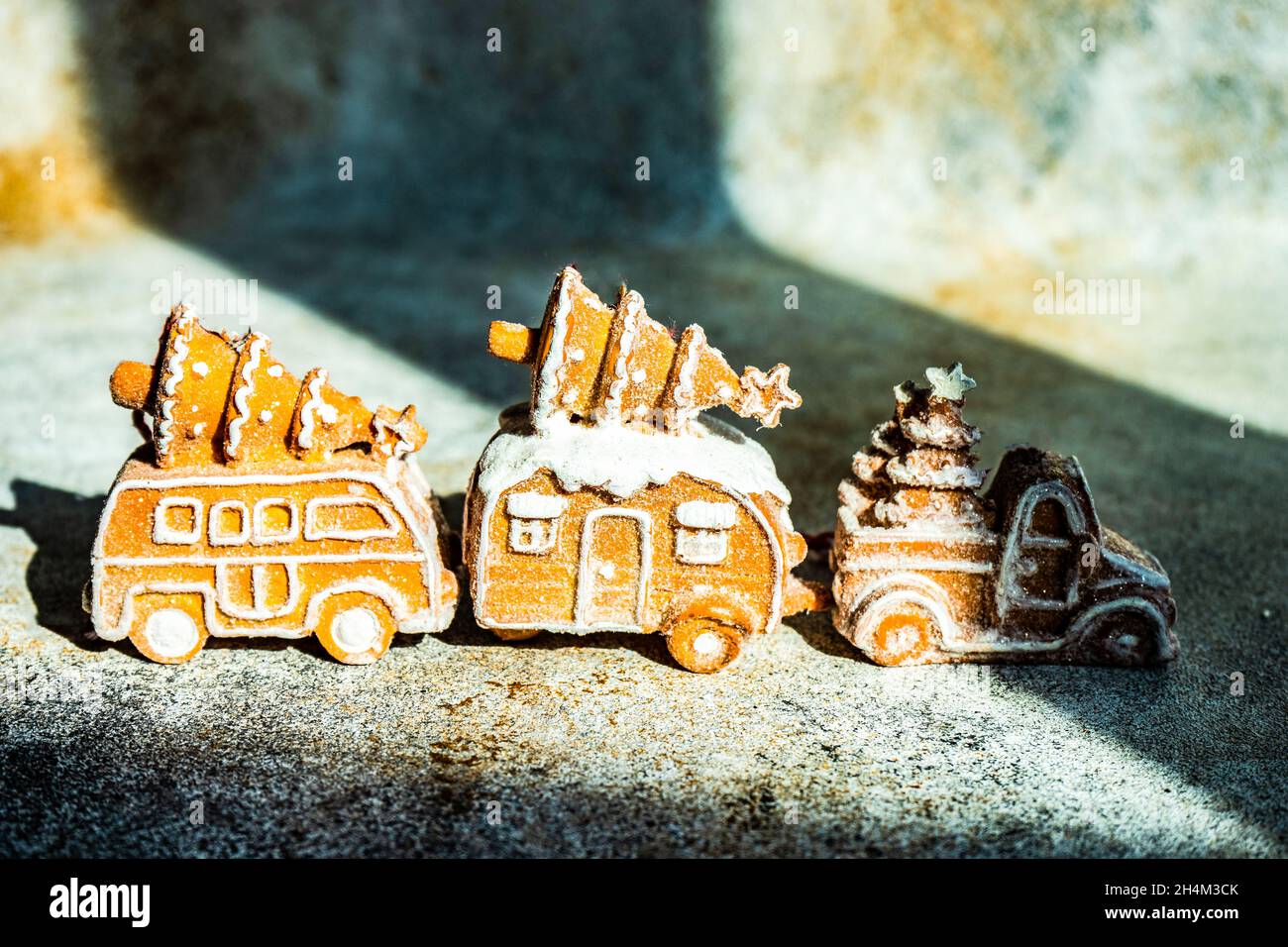 Gingerbread cookies shaped in cars and trucks covered with sugar as a ...