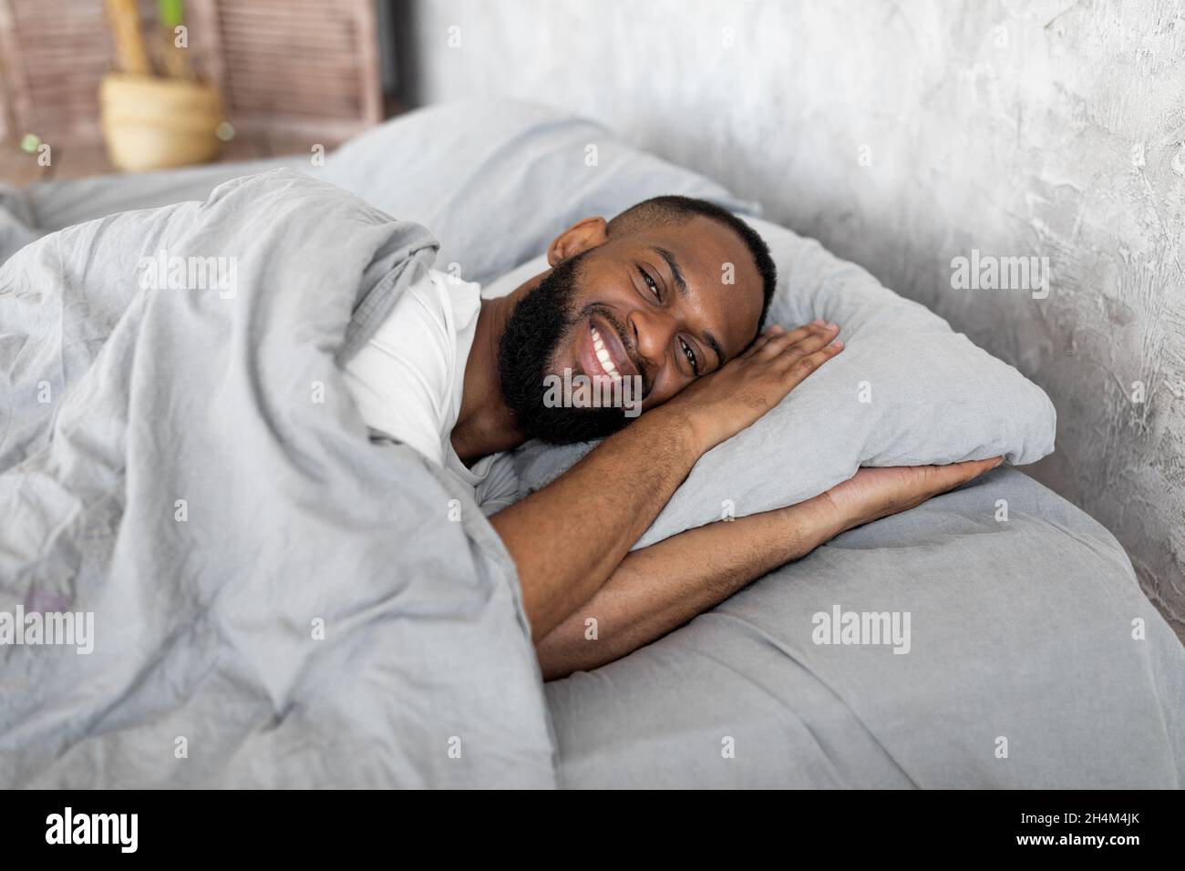 Good Morning. Cheerful young African male feeling good and rested after ...