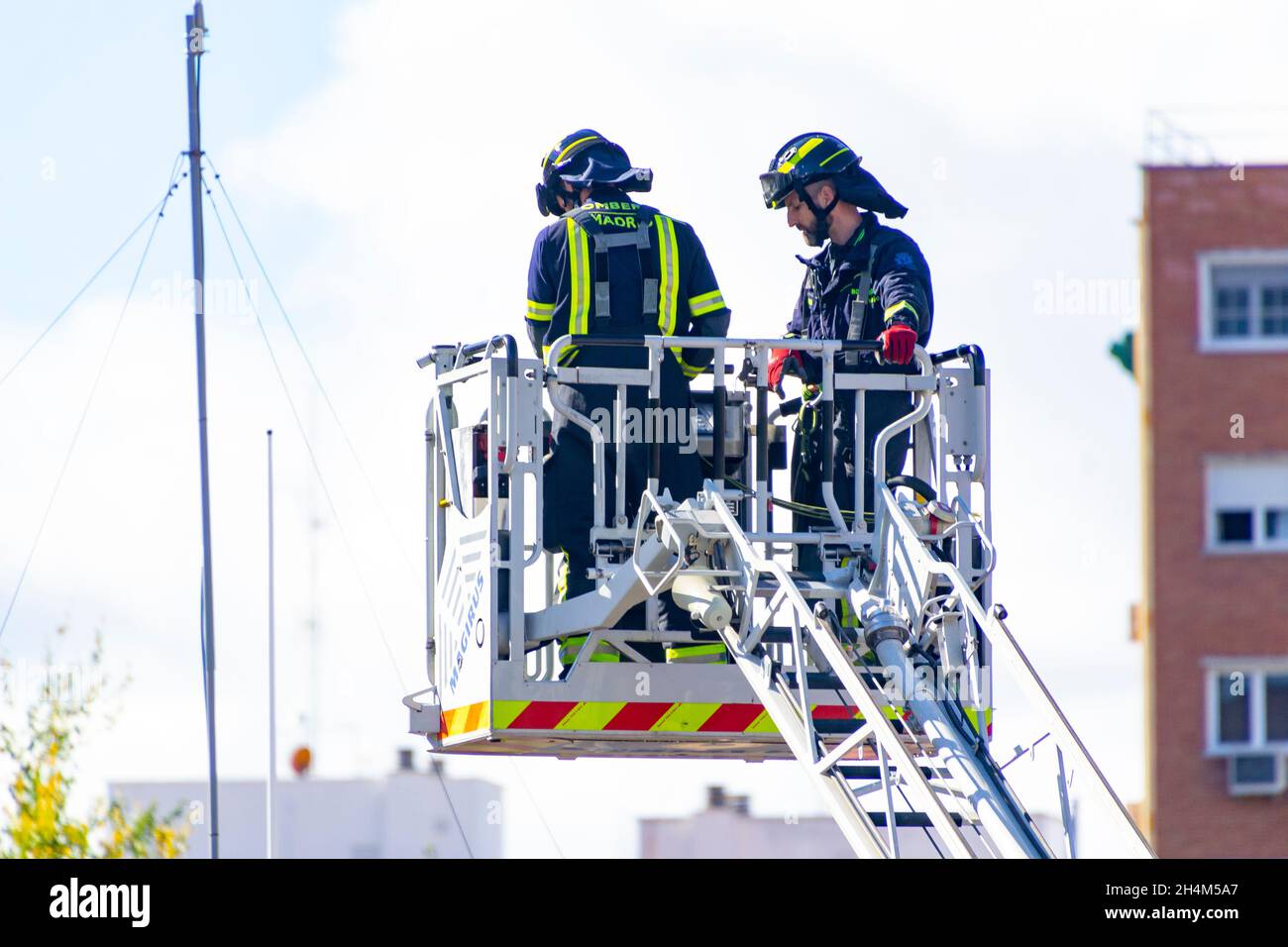 Firefighters climb a scale of a truck in one of the trainings in the ...