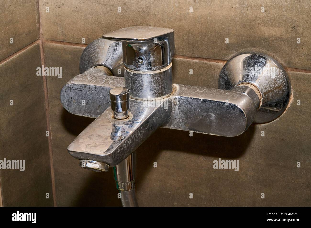 Closeup of shower mixer, covered by calcium stains because of hard ...