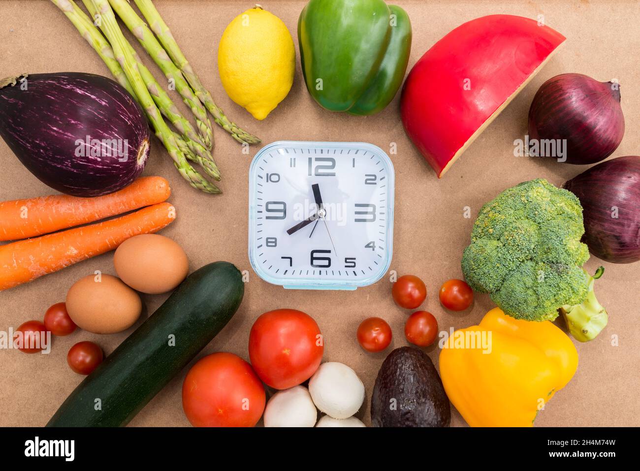 Healthy food and a clock on a wooden background. Conceptual photograph ...