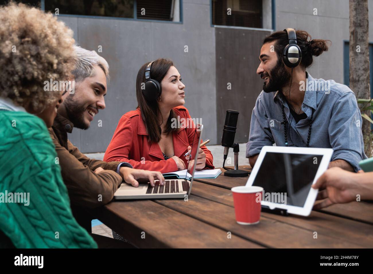 Multiracial people live streaming podcast outdoor - Focus on center ...