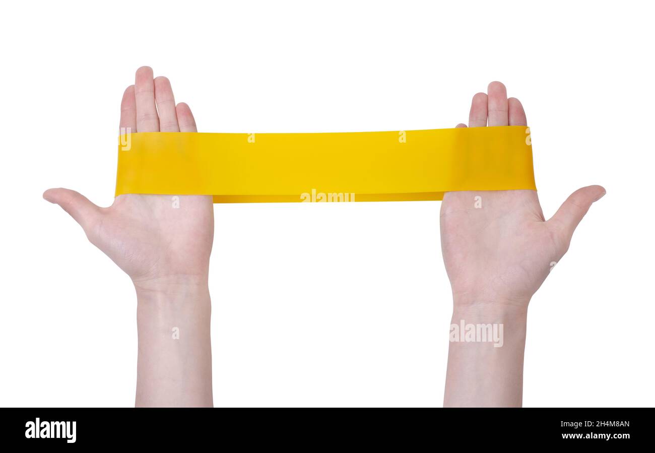 Fitness gums elastic yellow band in hands isolated on white background ...