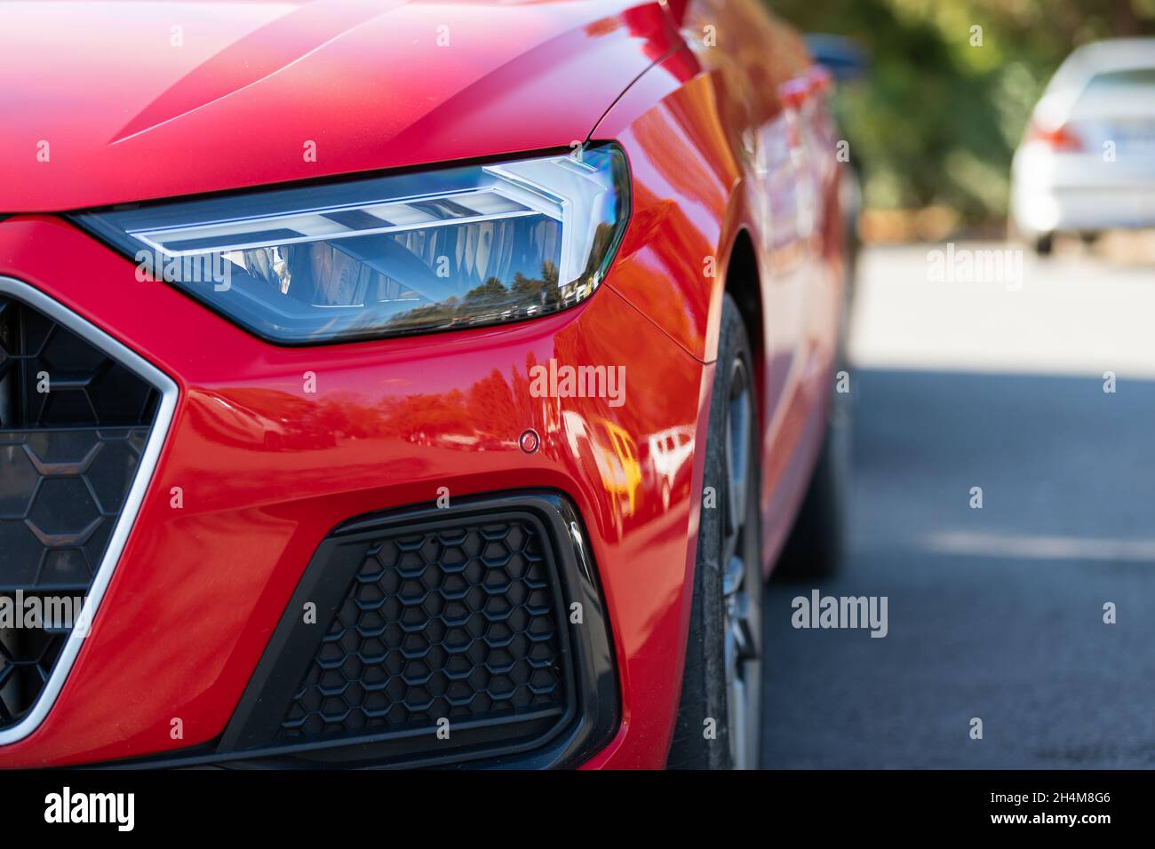 Close up picture of a shiny red car headlight Stock Photo - Alamy