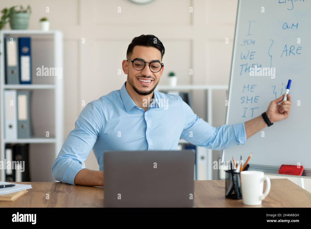 English teacher giving remote lesson on laptop pc, communicating with ...