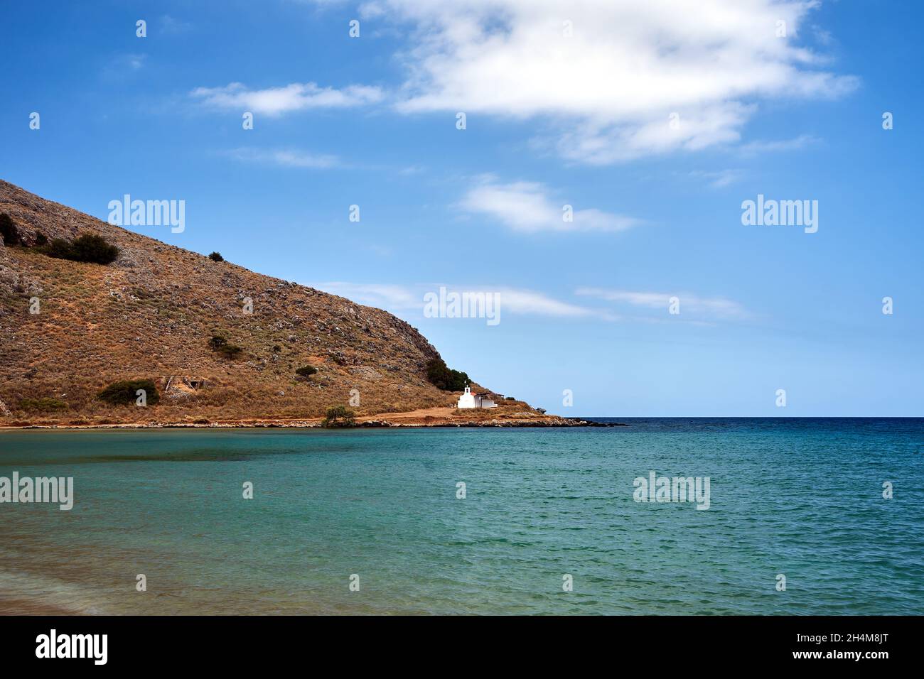 A white Orthodox chapel on the stone coast of Georgioupoli on the ...