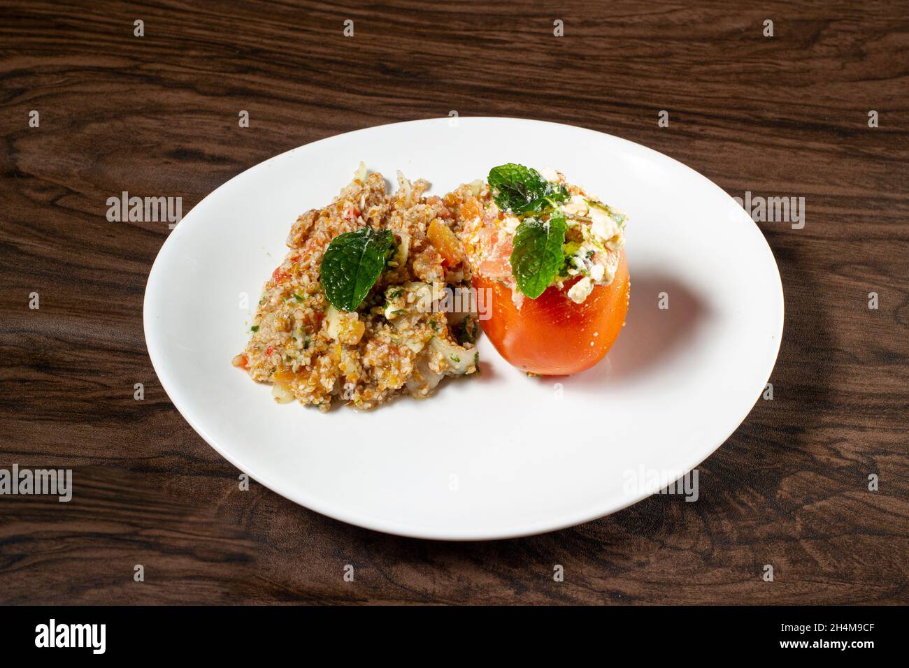 Tabbouleh Salad with stuffed tomato. Vegetarian food. Traditional ...