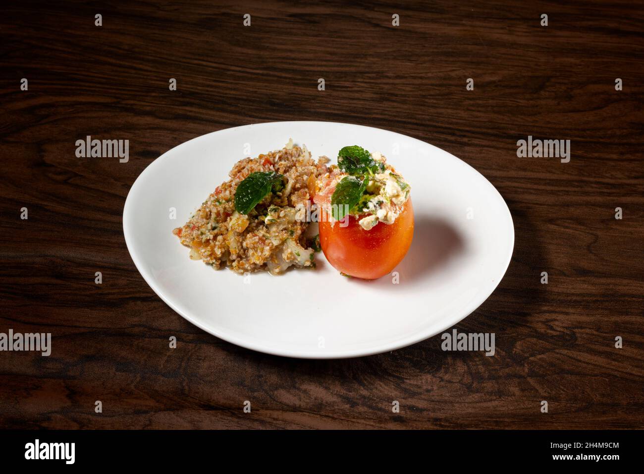 Tabbouleh Salad with stuffed tomato. Vegetarian food. Traditional ...