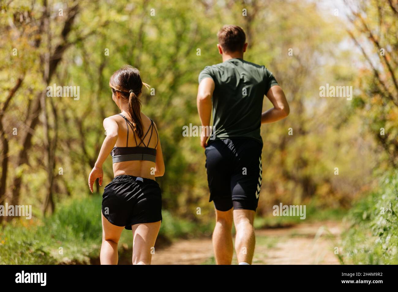 Sport people running in park together. Young couple jogging at outdoor ...