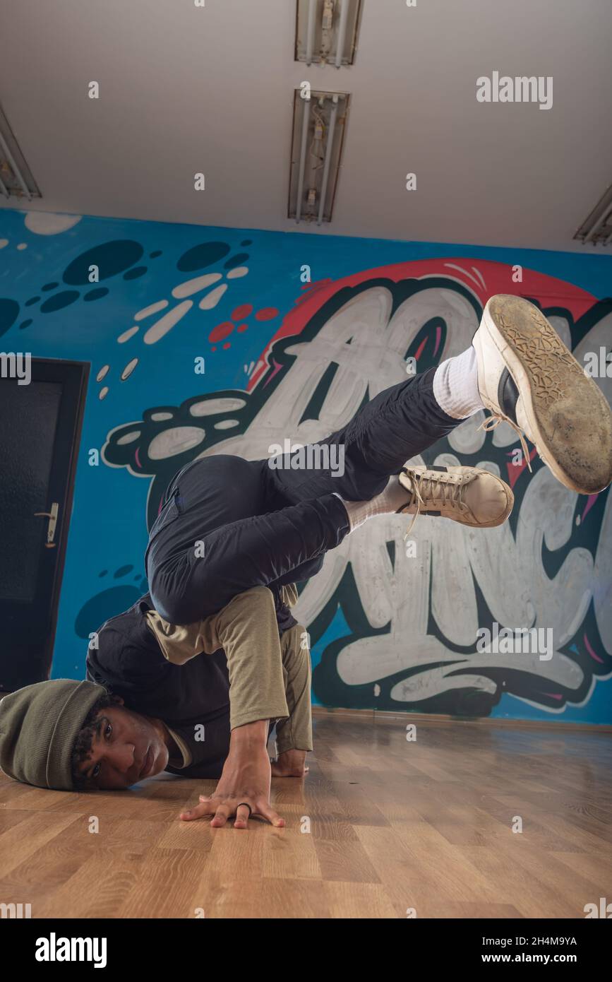 Modern rapper dancing in garage. Urban lifestyle, hip hop Stock Photo ...