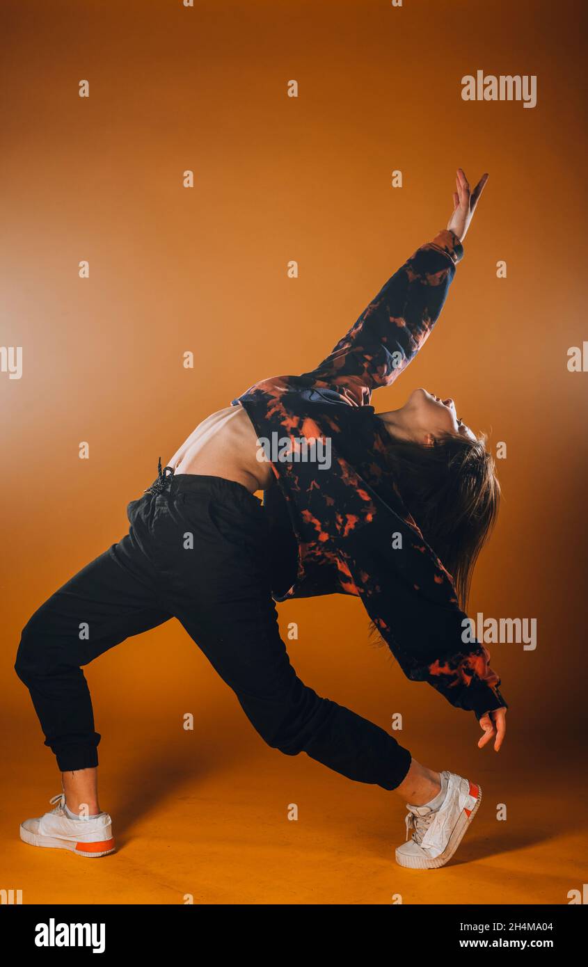 Slender flexible dance performer during a dance practice in modern ...
