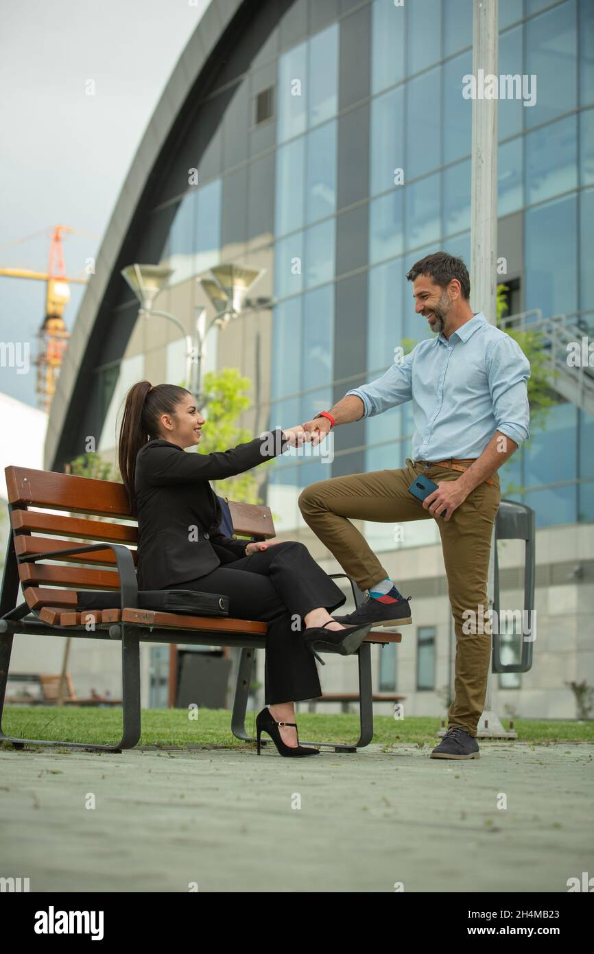 Two business people are talking and making deal while they are on their ...