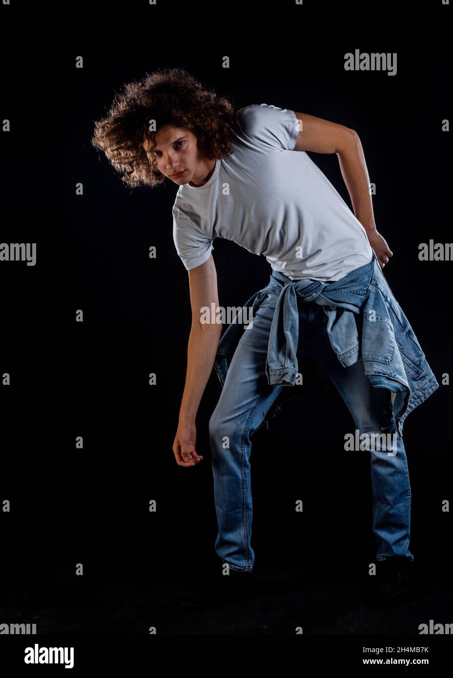 Portrait of an attractive young punk guy posing isolated on black background Stock Photo - Alamy