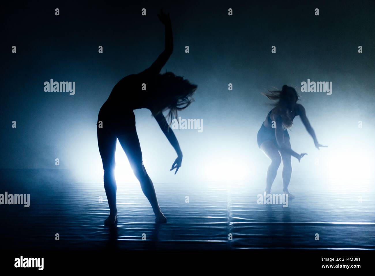 Graceful slender dancers performing a dance routine in the studio Stock ...