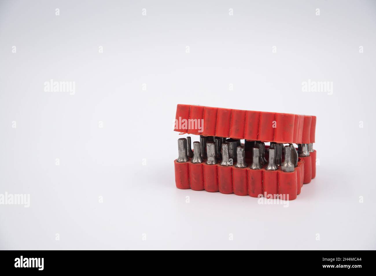 screwdriver head set in a red rubber package isolated on a white ...