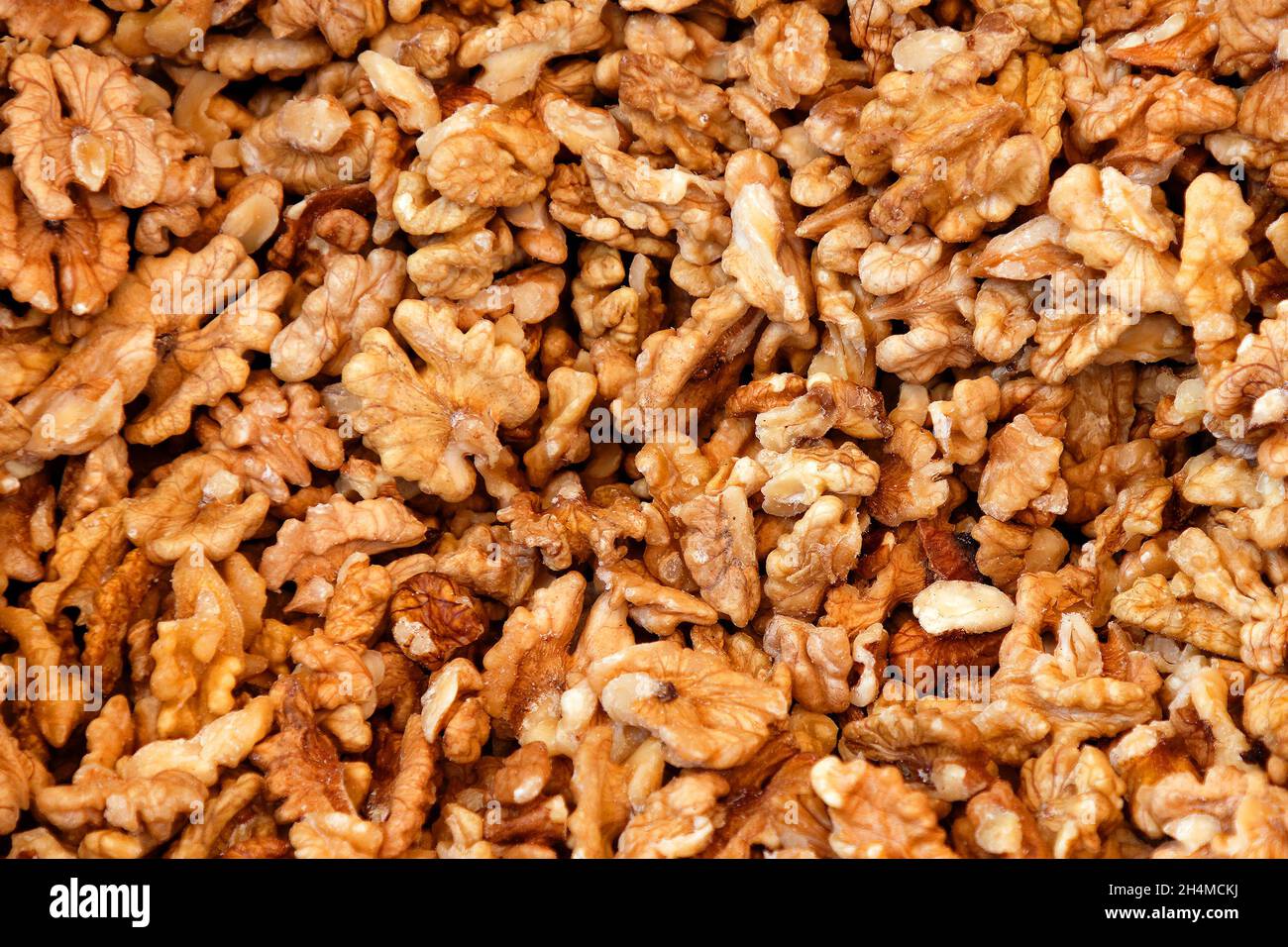 Raw walnuts outside of shell pile background pattern Stock Photo - Alamy
