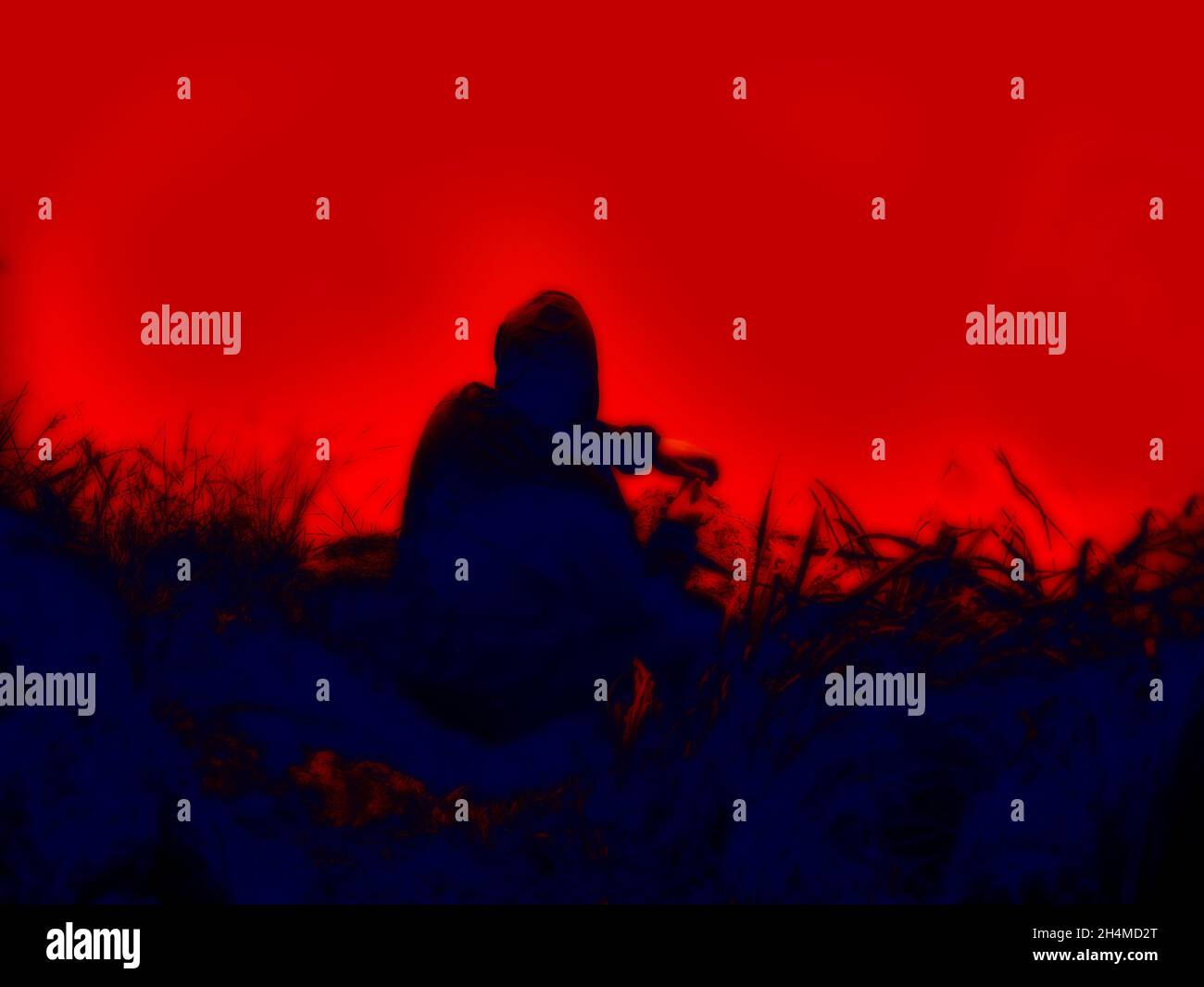 Hooded man sits over precipice. Scanning people's body temperature with ...