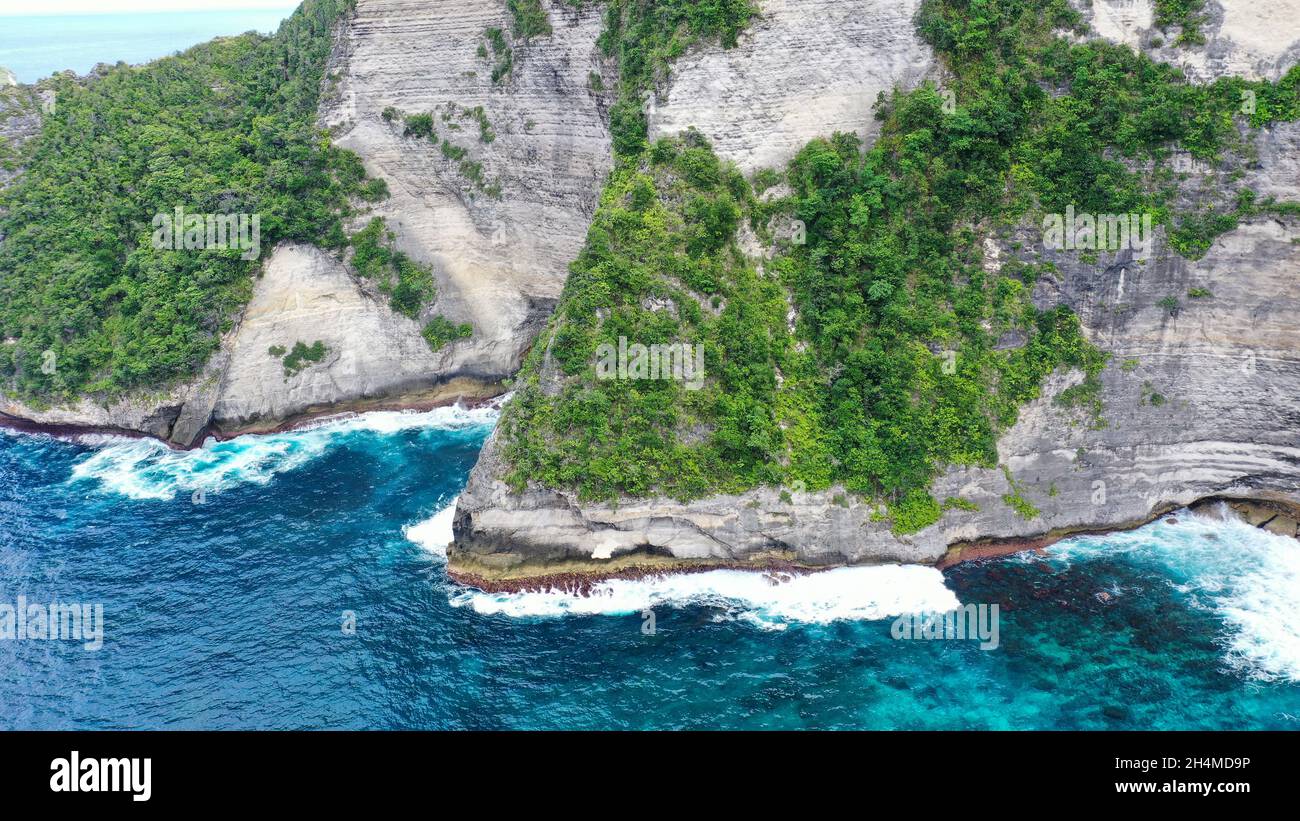 Taken by drone the view of the green cliffs with the beauty blue ocean ...