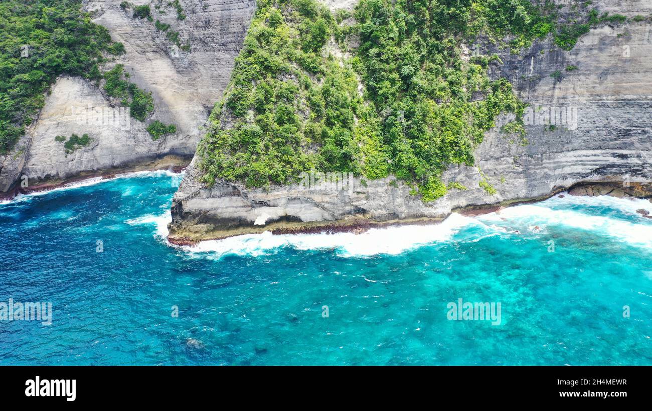 Taken by drone the view of the green cliffs with the beauty blue ocean ...