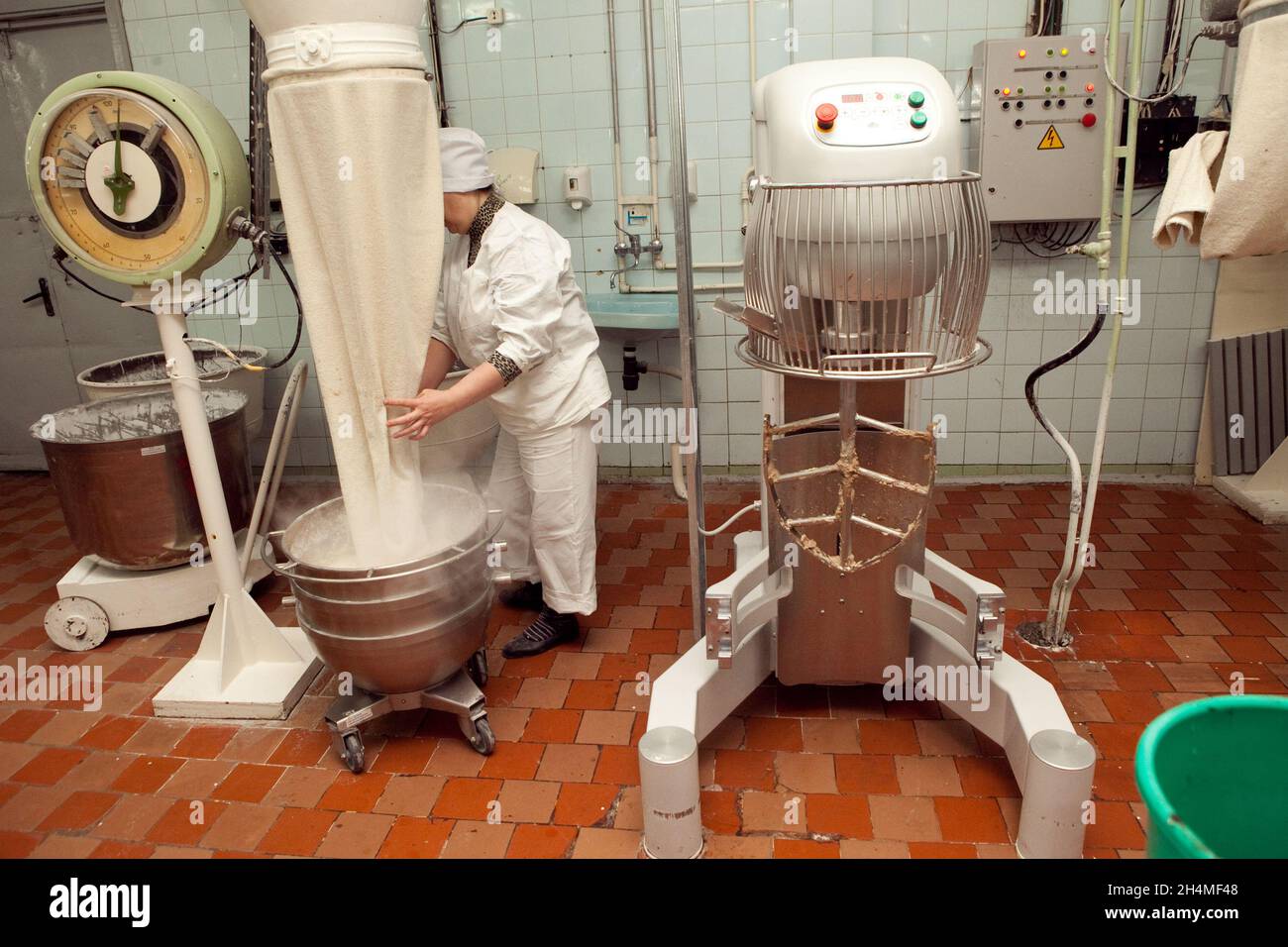The process of making cookie dough in an industrial kneading machine at ...