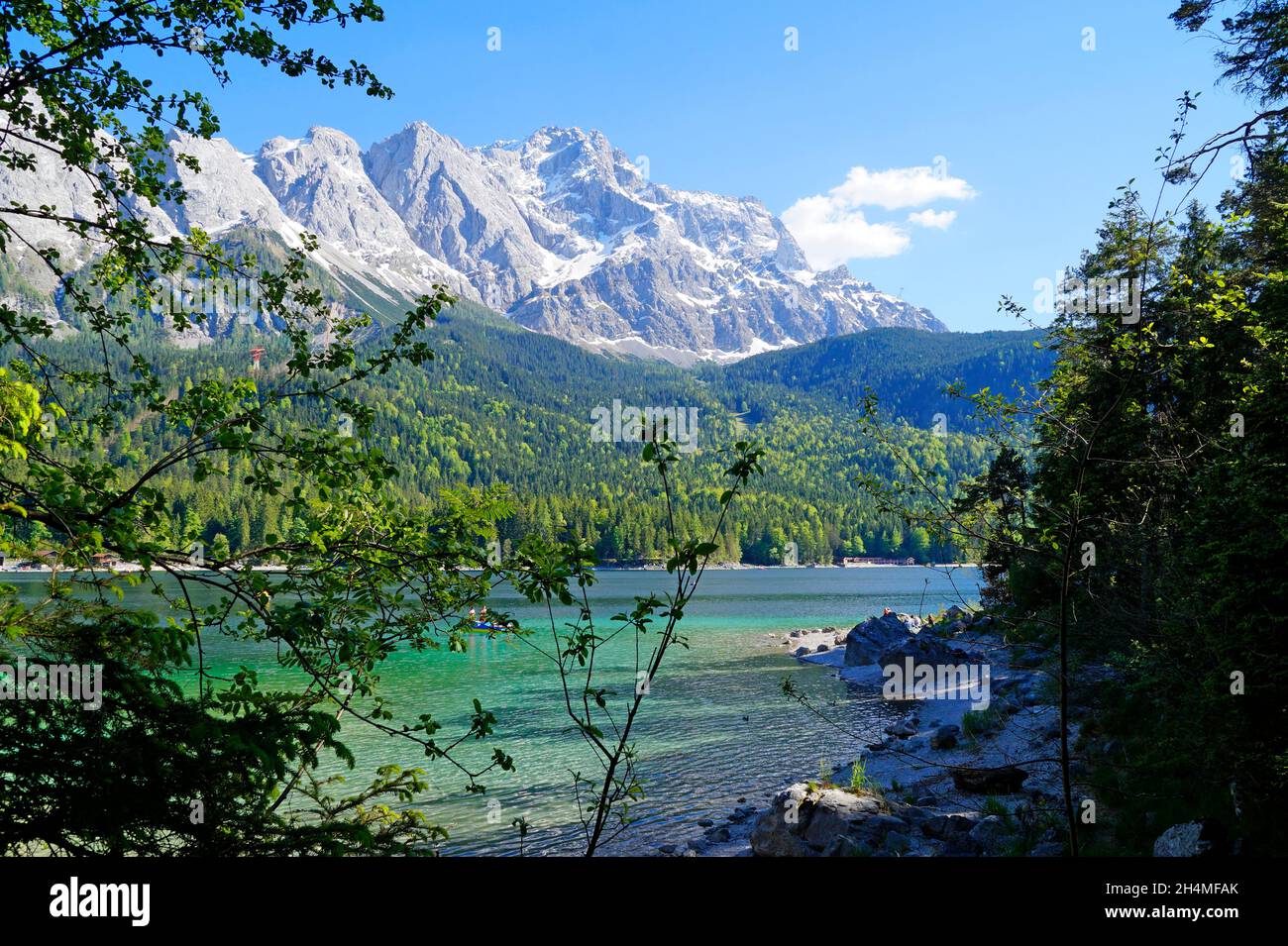 picturesque turquoise lake Eibsee by the foot of mountain Zugspitze in ...
