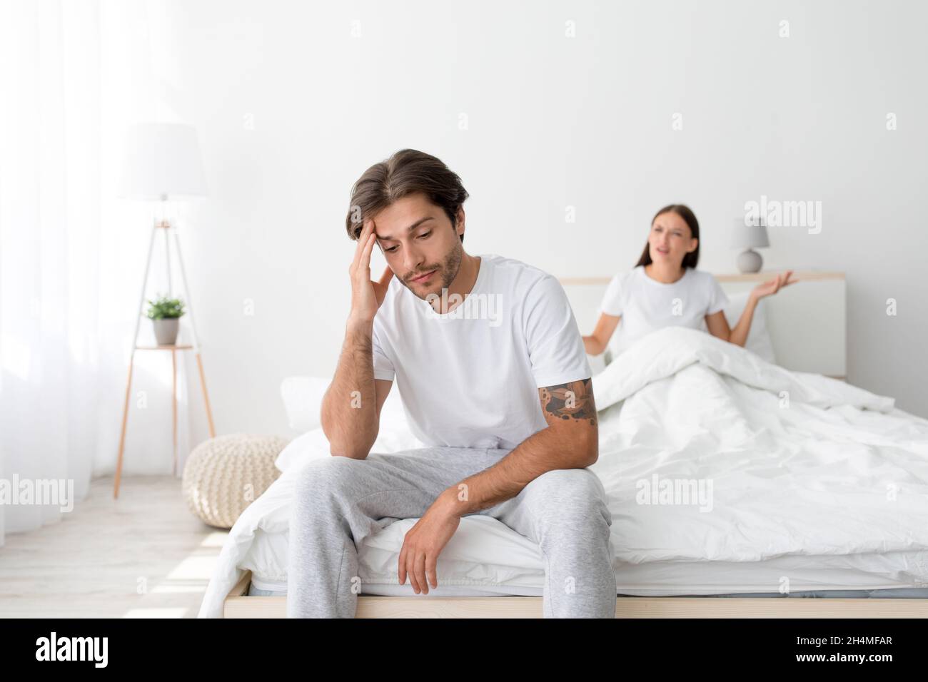 Angry Resentful Upset Millennial Caucasian Wife Sits On Bed Quarreling