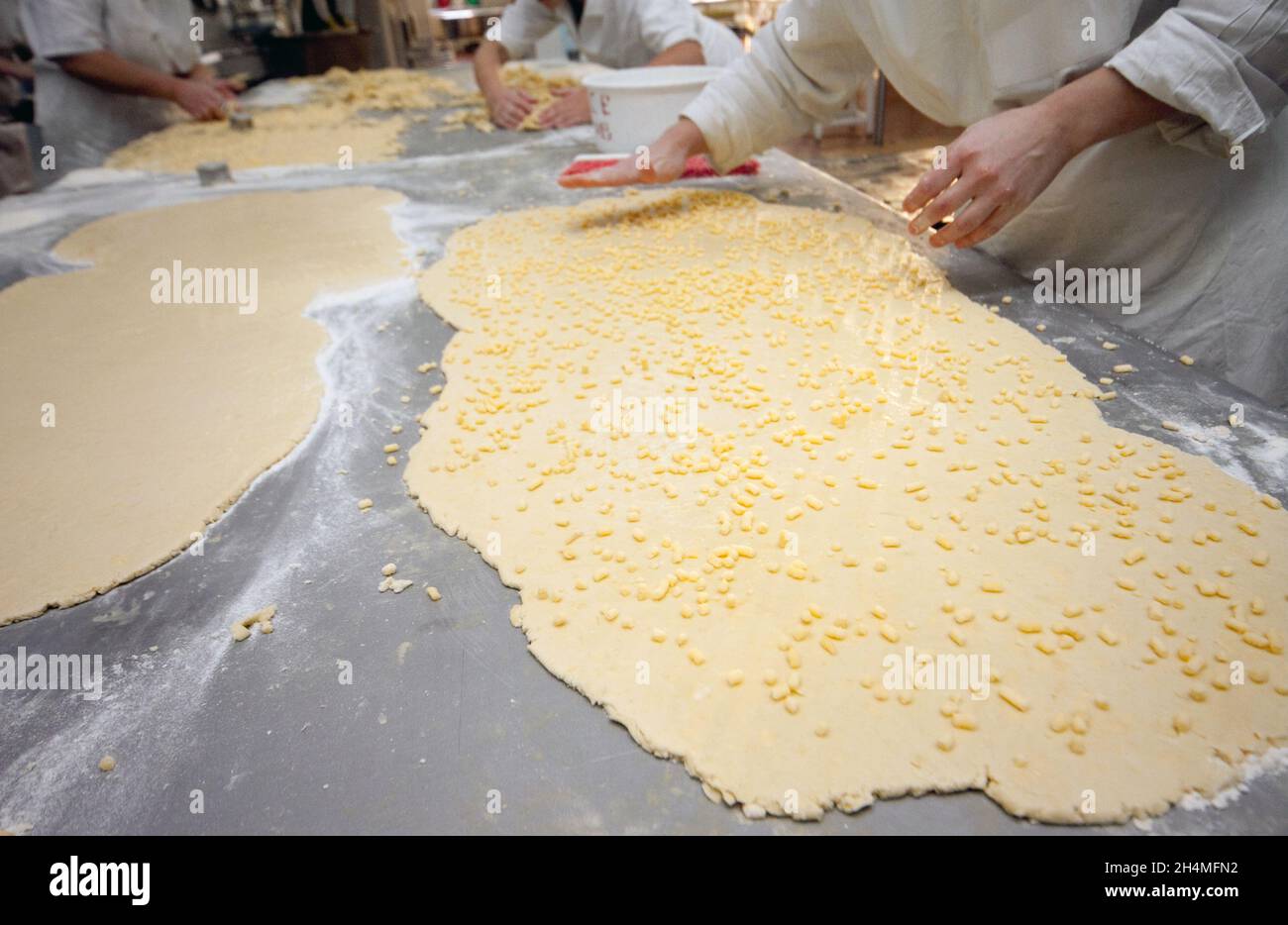 Manual cutting of dough for making cookies at the factory in the bakery ...