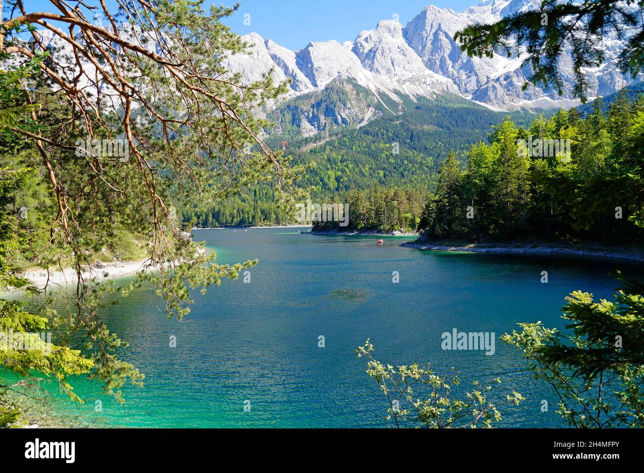 picturesque little island on turquoise lake Eibsee by the foot of ...