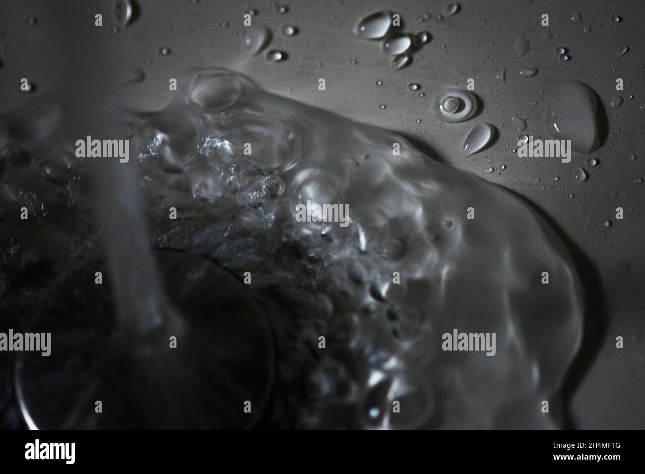 water running down the drain from a tap Stock Photo - Alamy