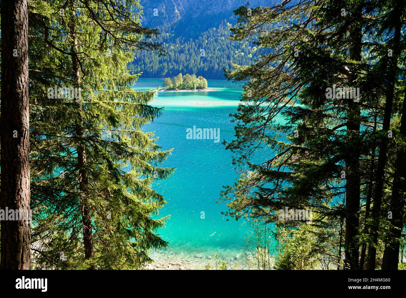 picturesque little island on turquoise lake Eibsee by the foot of ...