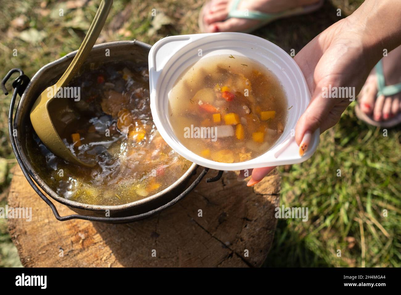 ready mushroom soup cooked over a fire is poured into a plate Stock ...