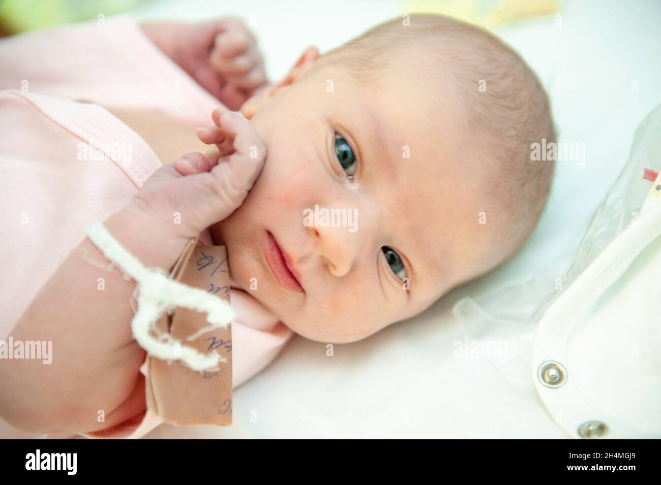 a newborn baby on the first day of its birth in the maternity hospital ...