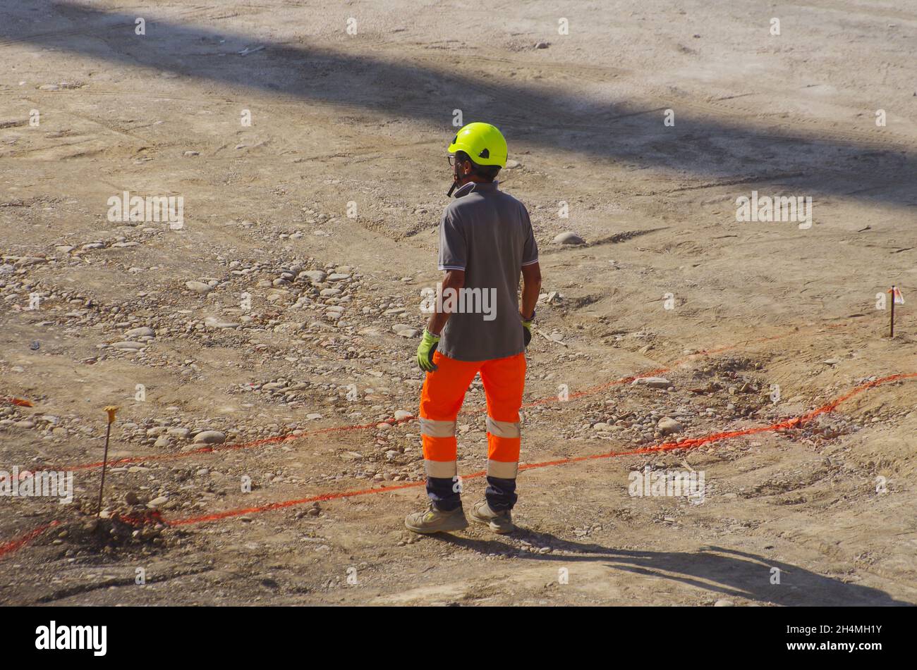 A worker with safety equipment at work on a construction site Stock ...