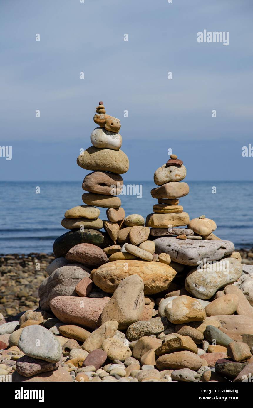 Cairns built by visitors to Lindisfarne Castle on Holy Island, off the ...