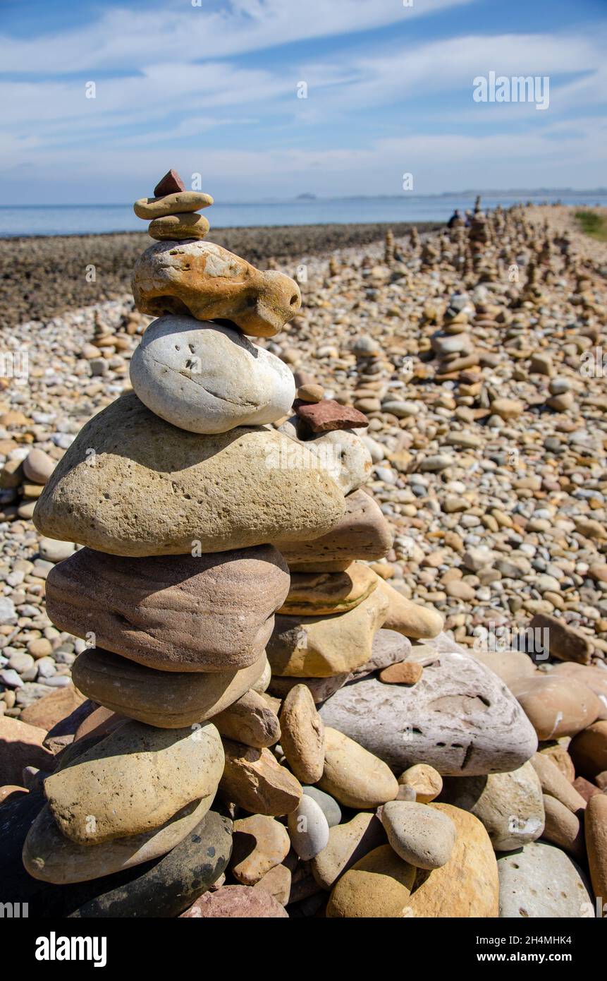 Cairns built by visitors to Lindisfarne Castle on Holy Island, off the ...