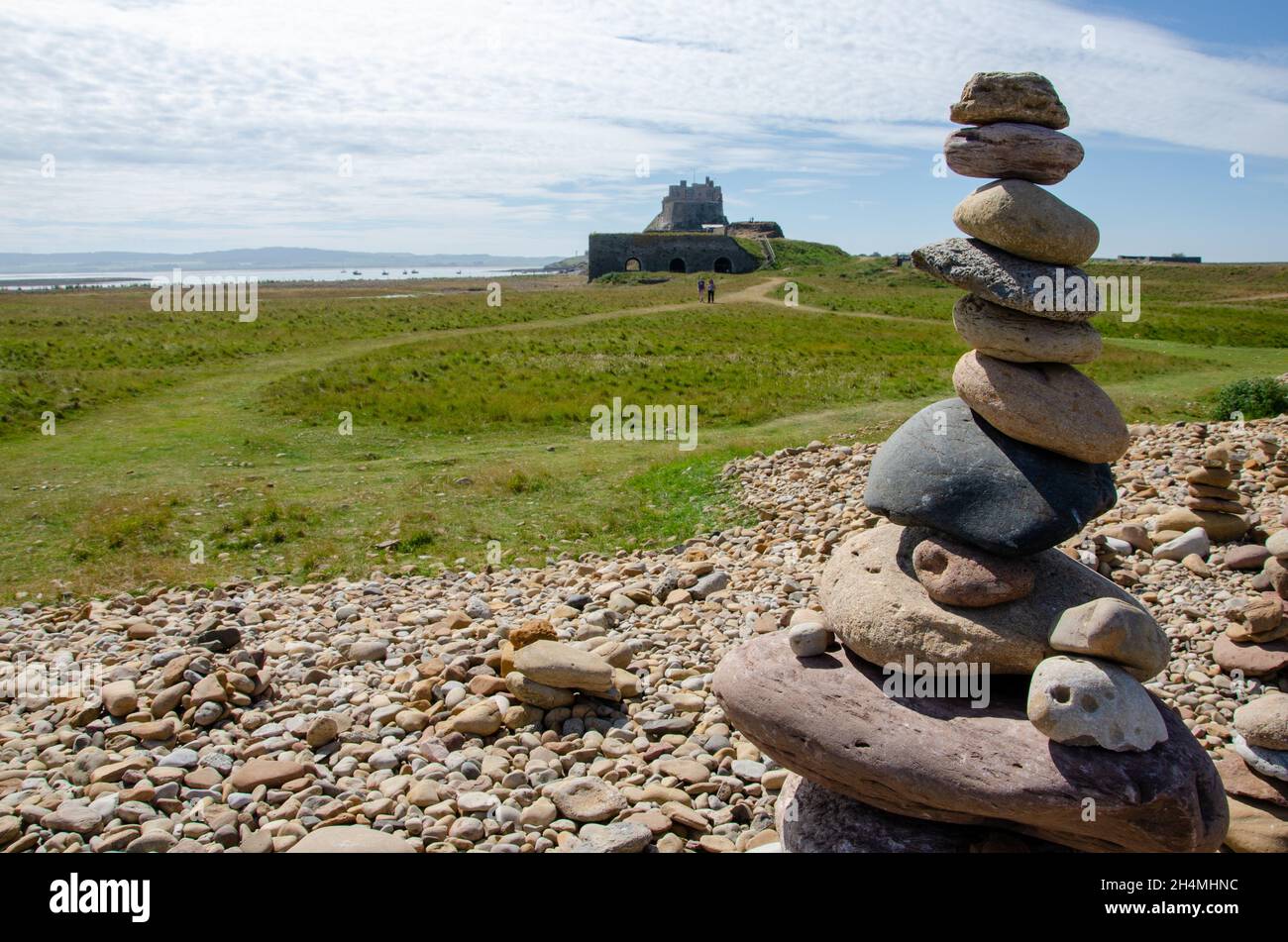 Cairns built by visitors to Lindisfarne Castle on Holy Island, off the ...