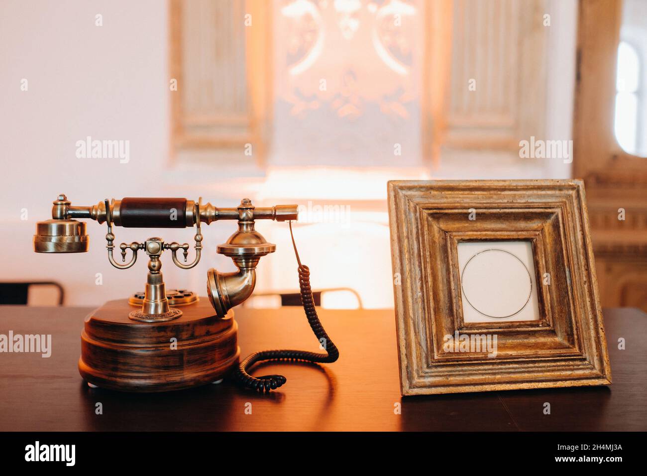an old retro phone stands next to an empty photo frame.Vintage phone ...