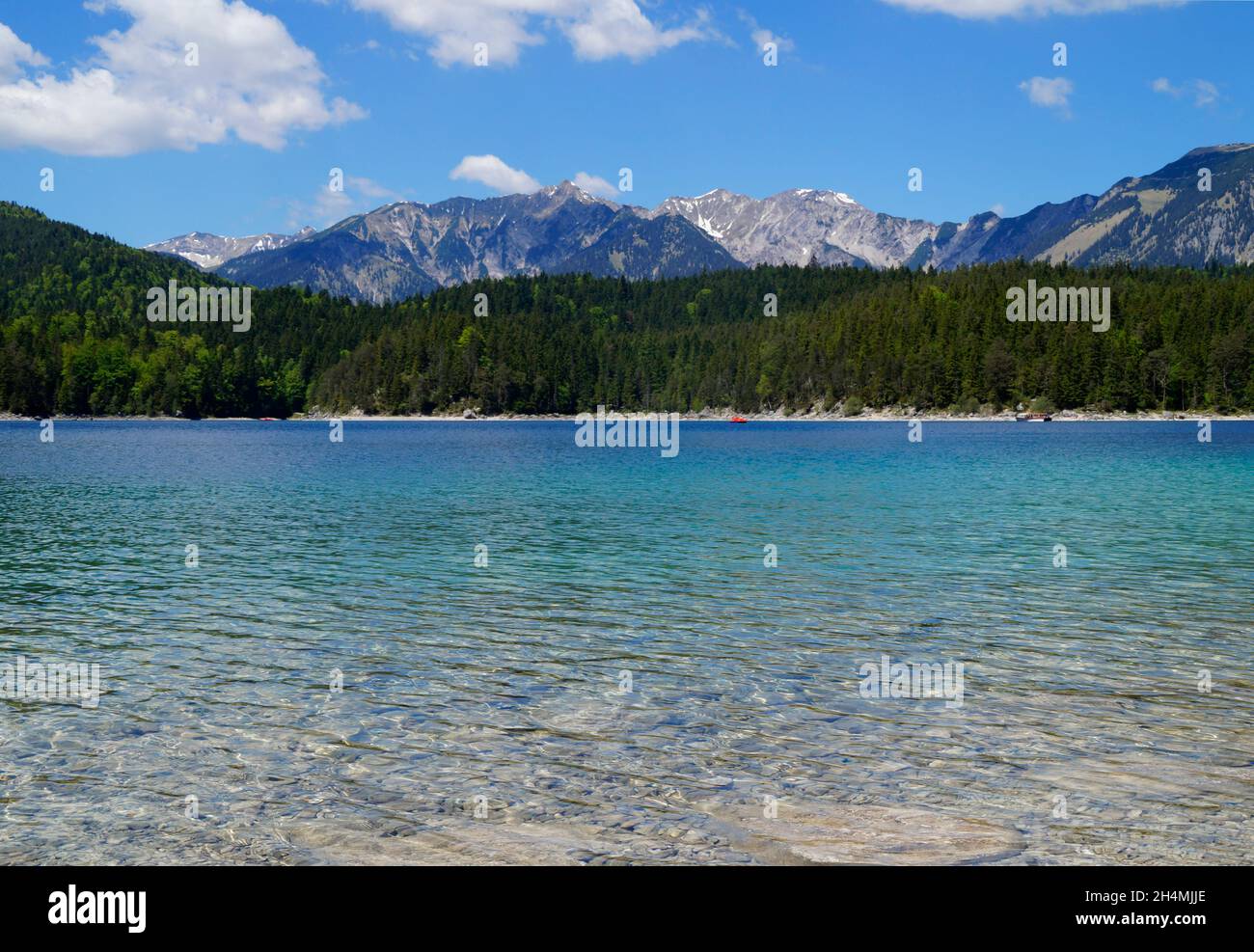 picturesque turquoise lake Eibsee by the foot of mountain Zugspitze in ...