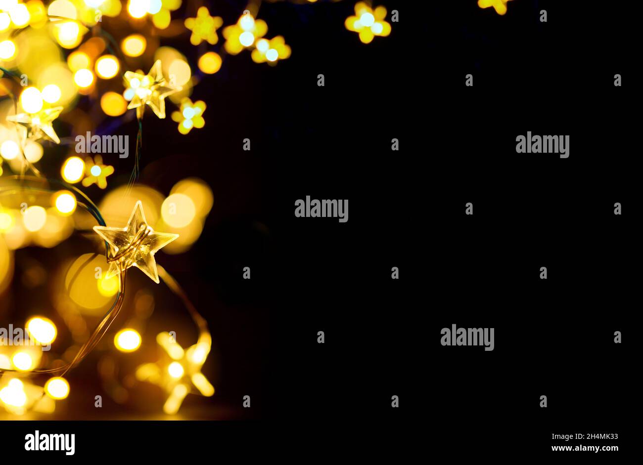 Christmas Holidays Gold star light hanging on dark background Stock ...