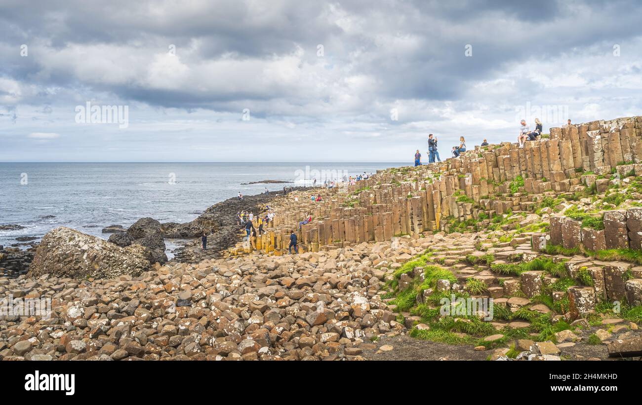 Bushmills, Northern Ireland, Aug 2019 Tourists photographing hexagonal ...