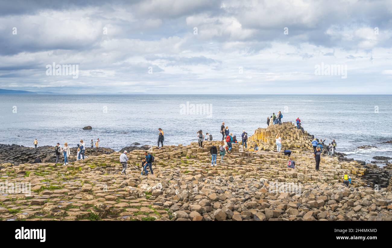 Bushmills, Northern Ireland, Aug 2019 Tourists sightseeing hexagonal ...