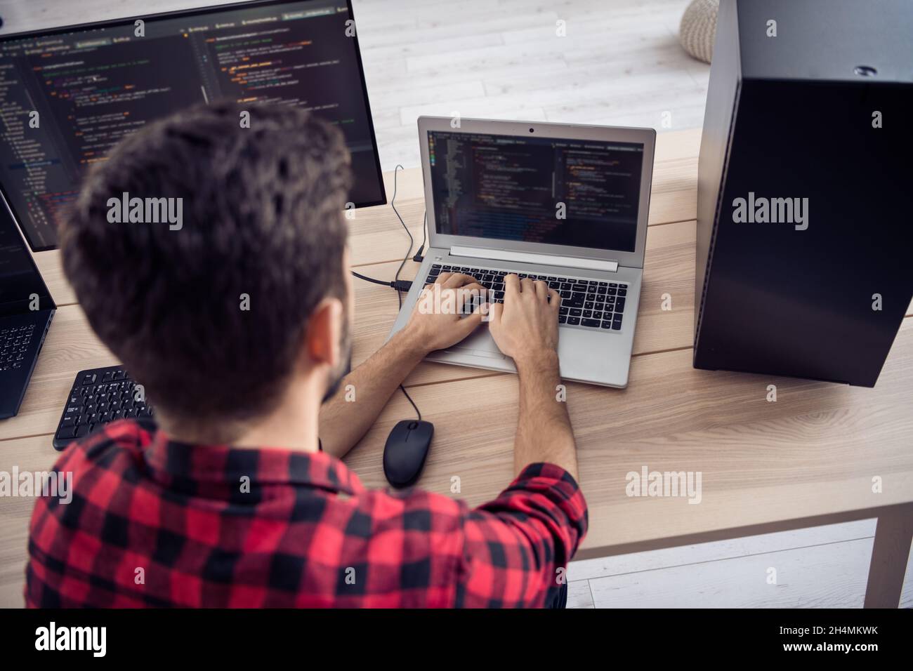 Back rear spine view photo of young man sit table work pc computer geek ...