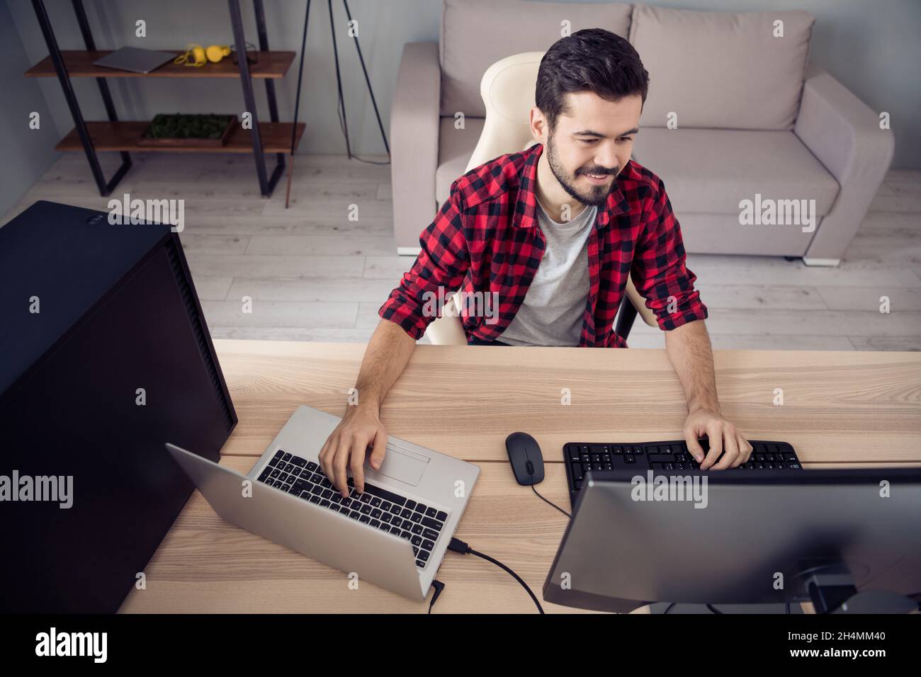 Photo of happy attractive young man look computer web designer good ...