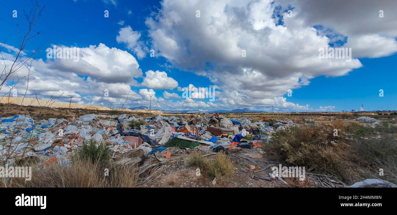 Rubbish on the ground under blue sky with clouds - environmental ...