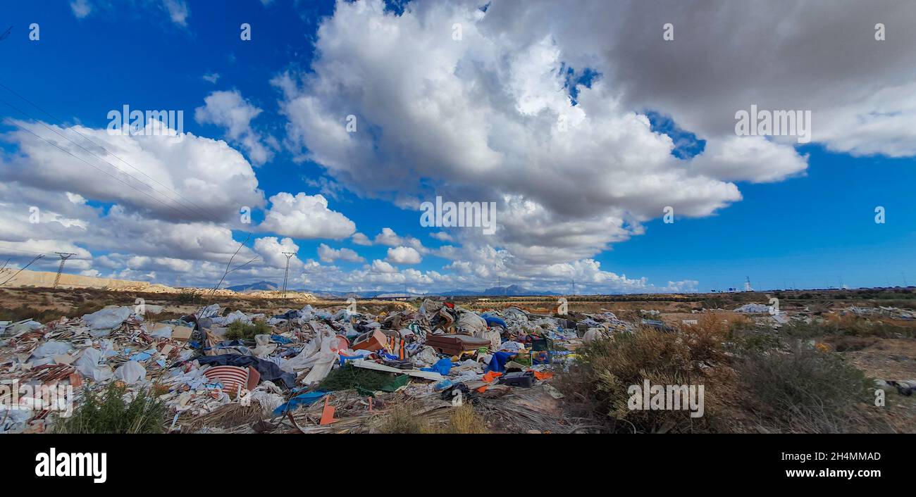 Rubbish on the ground under blue sky with clouds - environmental ...