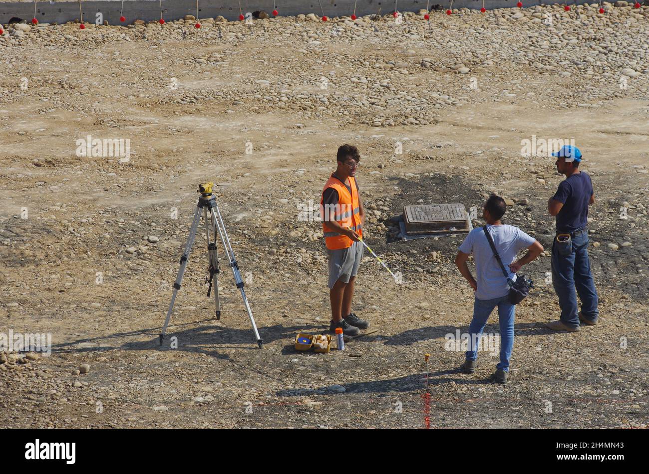 Some technicians perform measurements on a construction site Stock ...