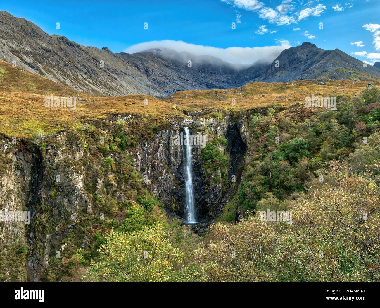 Eas Mor waterfall with Coire na Banachdich in the Black Cuillin ...